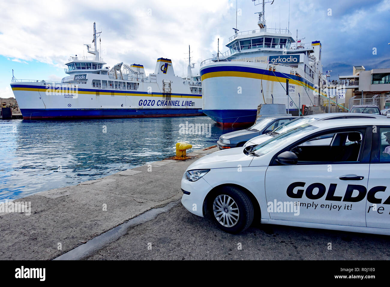 Tourists' hire cars parked next to the Malta ferry ships at the Mgarr ...