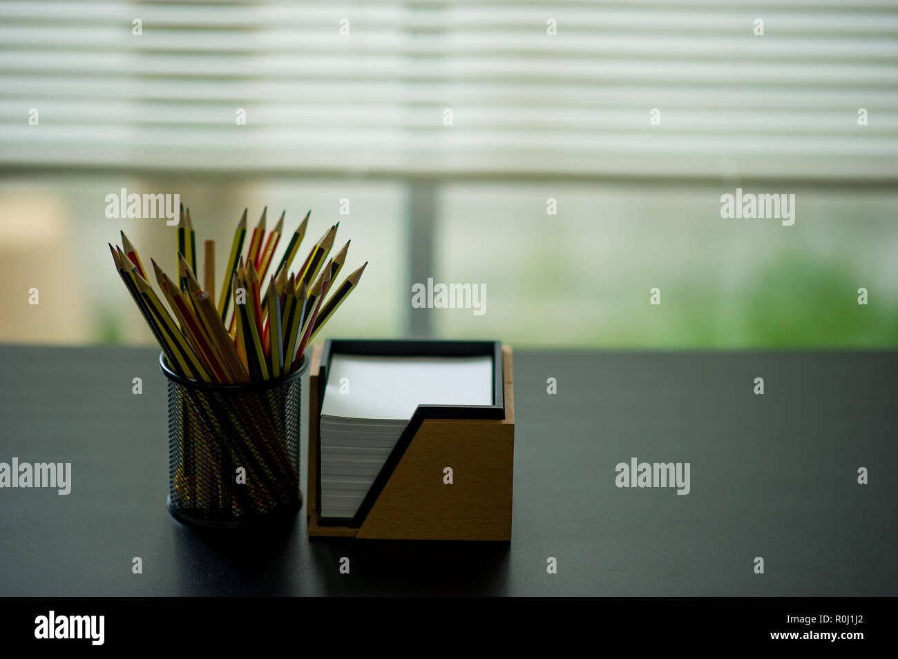 Pencil and note Placed on the executive desk. Placed by the window ...