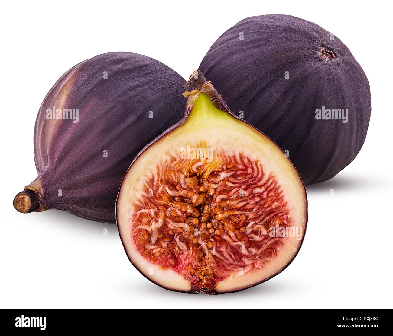 Two fresh figs fruit one cut in half isolated on white background ...