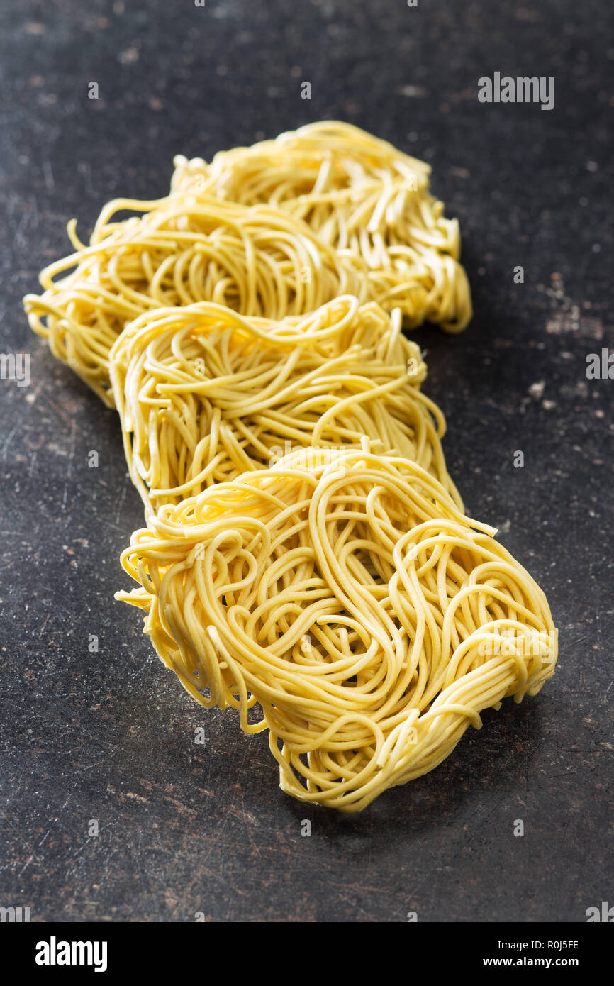Uncooked instant chinese noodles on old kitchen table Stock Photo - Alamy