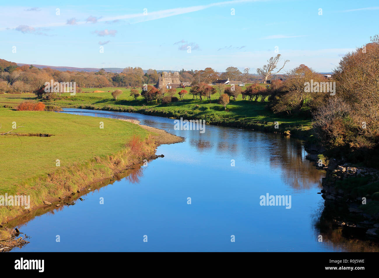 Looking along the banks of Ogmore river towards Ogmore castle ruins on ...