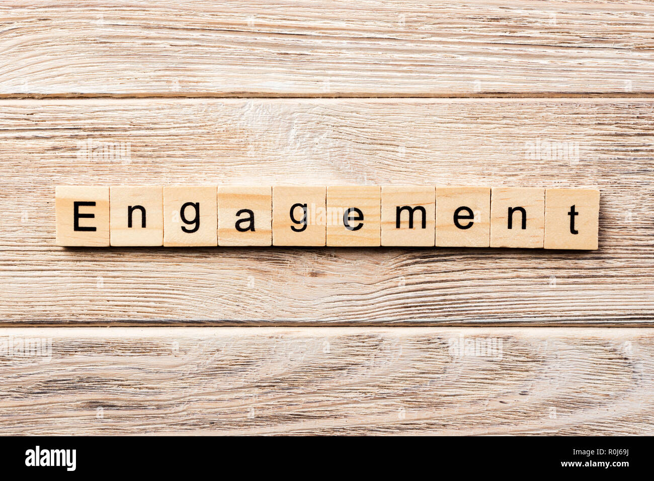 engagement word written on wood block. engagement text on table ...