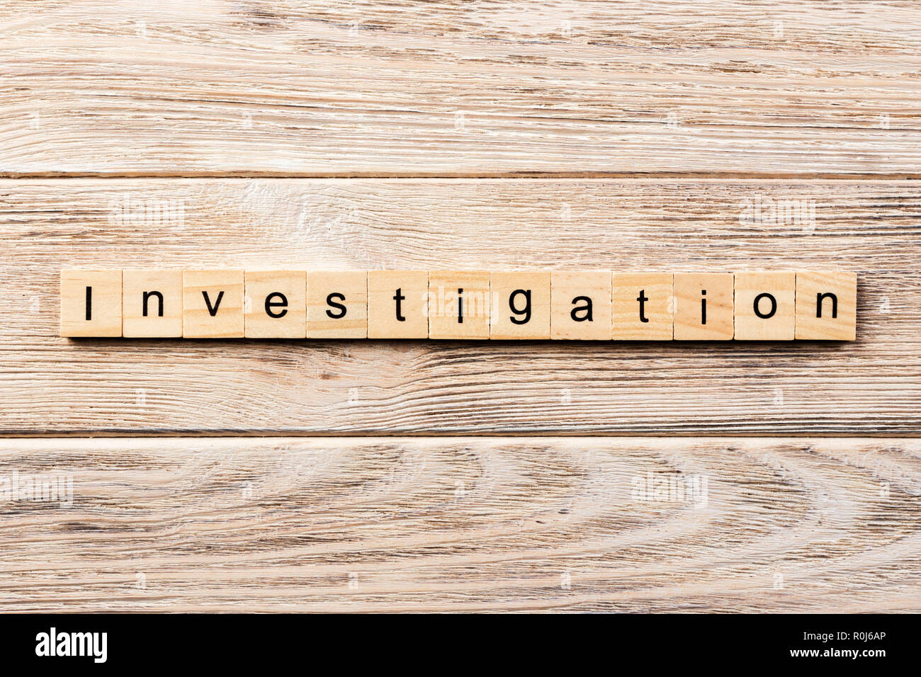 investigation word written on wood block. investigation text on table ...