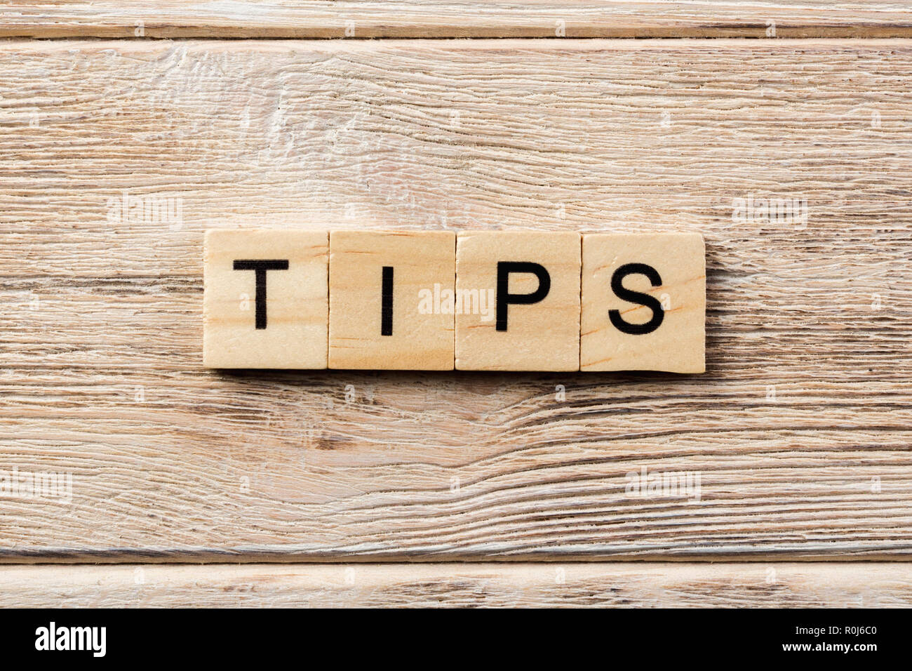 tips word written on wood block. tips text on table, concept Stock ...