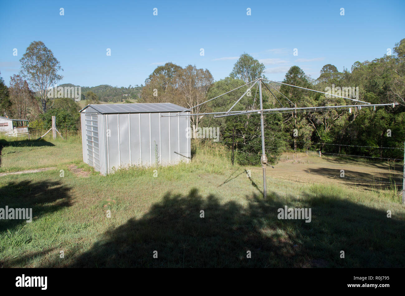 Australian tin shed in a rural backyard with a rotary clothes washing ...