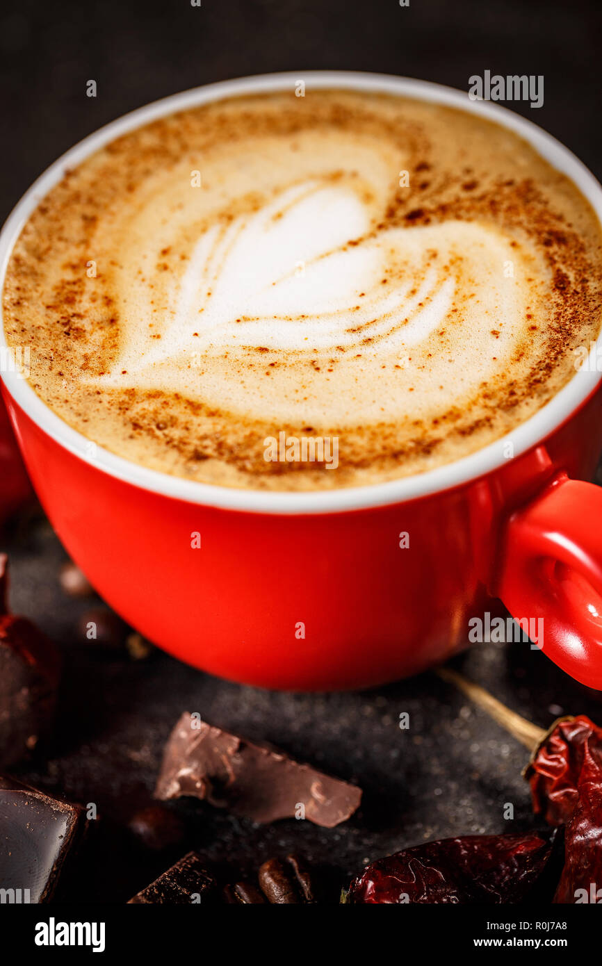 Close up of chili and chocolate flavored coffee on dark background ...