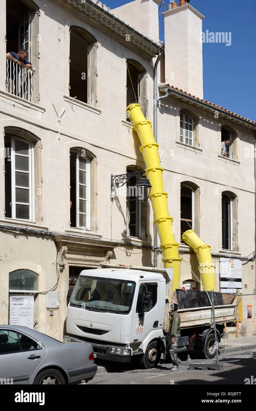 Rubbish Shoots and Builder's Truck in Use During Renovation or ...