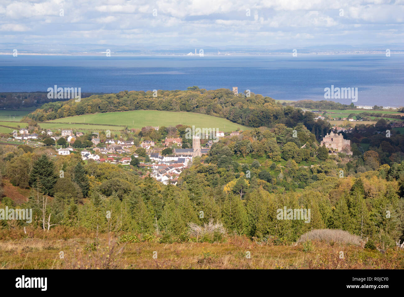 Autumn light over Dunster village and Castle, Exmoor National Park ...