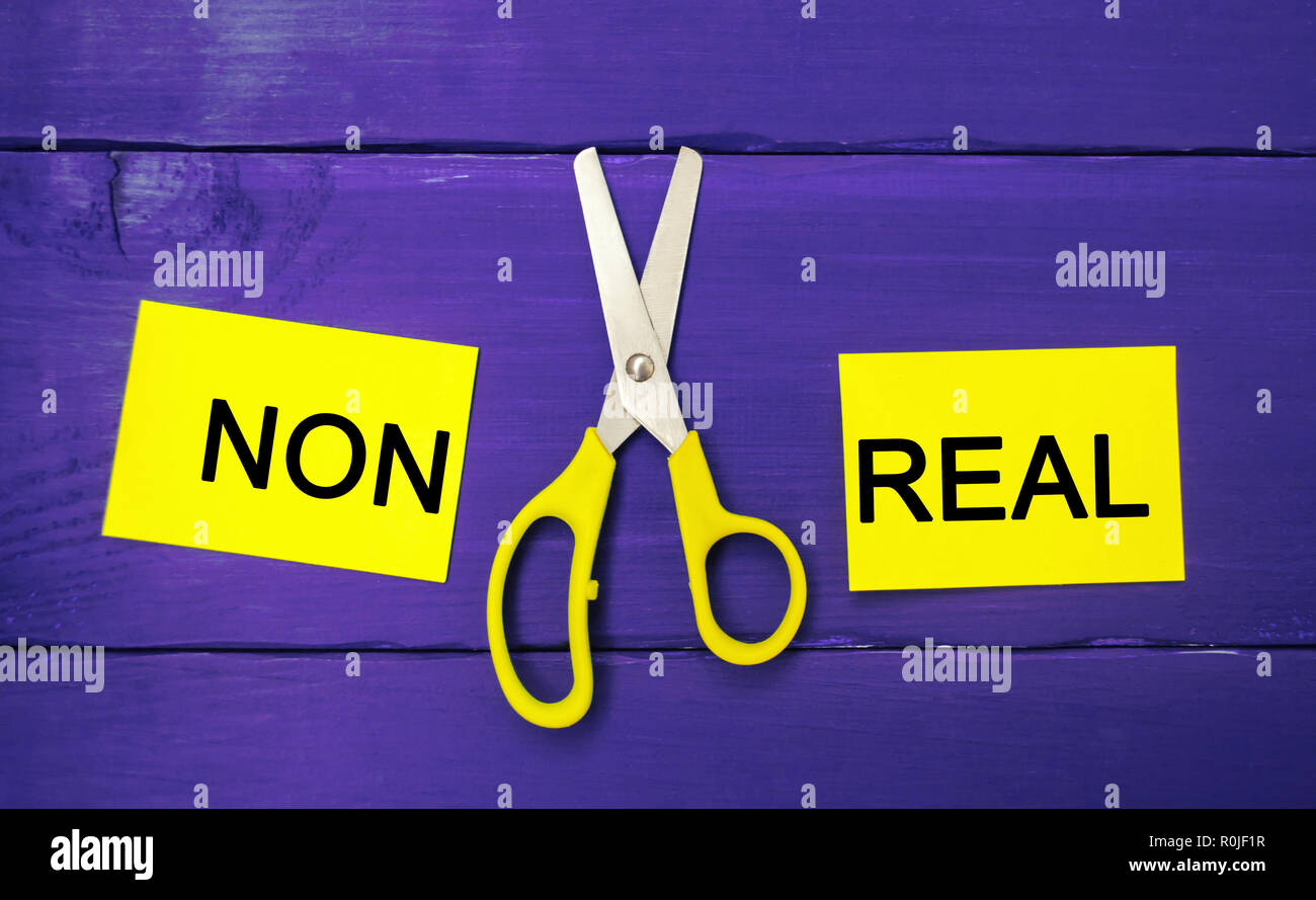 concept of motivation. the inscription "non real" and scissors between ...