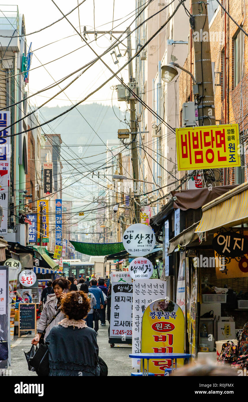 Busy street market scene in Busan, South Korea. Street is full or ...