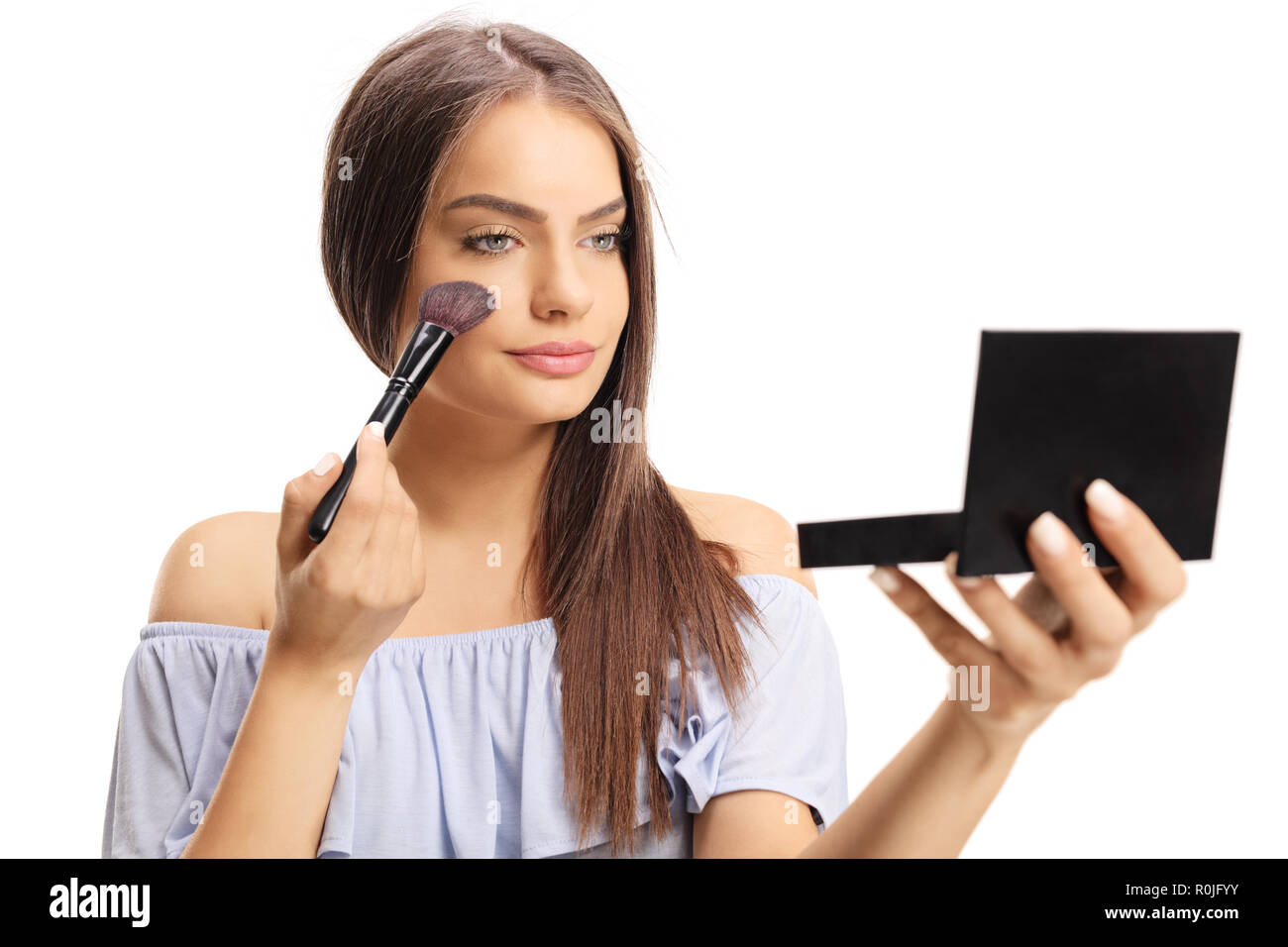 Young woman applying make-up isolated on white background Stock Photo ...
