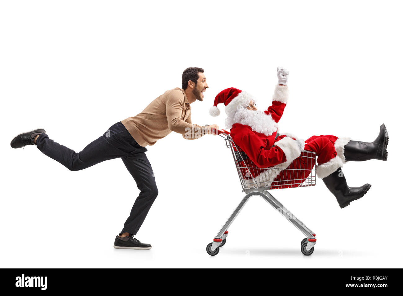 Young man pushing Santa Claus inside a shopping cart isolated on white ...