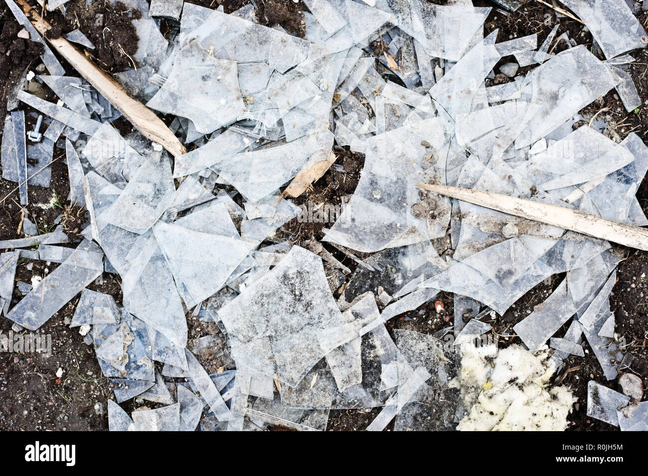 Broken window glass in the ground Stock Photo - Alamy