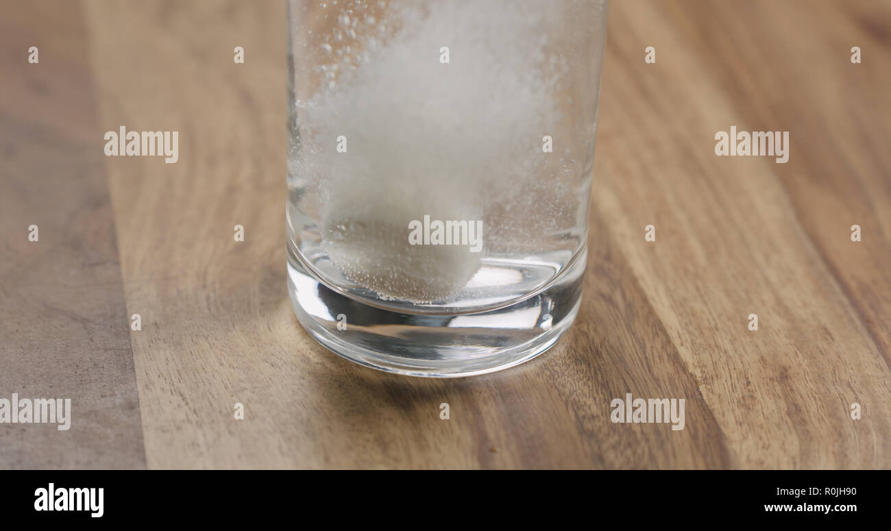 effervescent tablet in glass of water on wood table, wide photo Stock ...