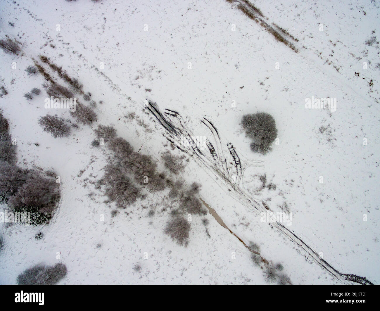 drone image. aerial view of rural area with fields and forests in snowy ...