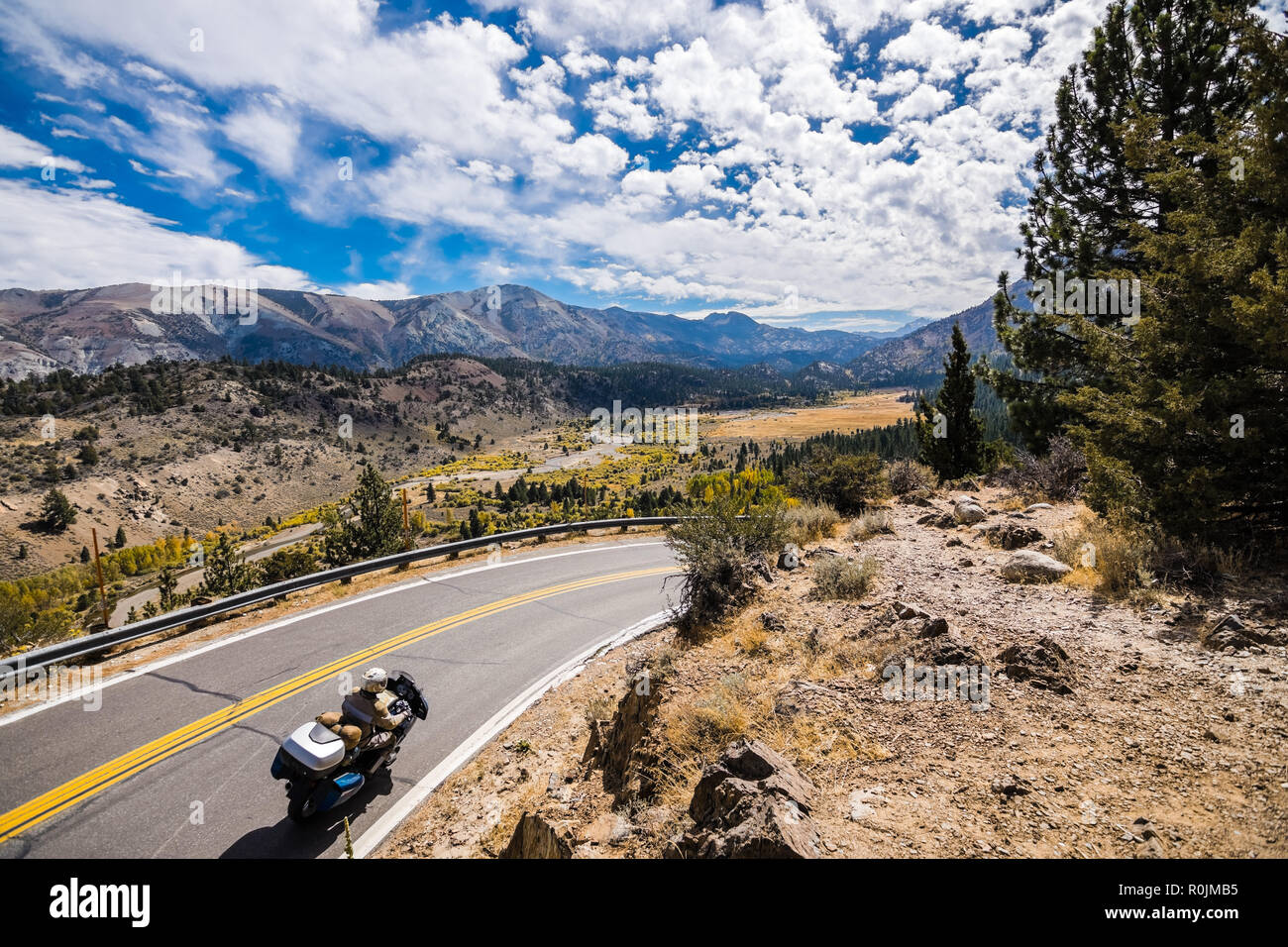 Travelling on a motorcycle towards Sonora Pass; beautiful alpine valley ...