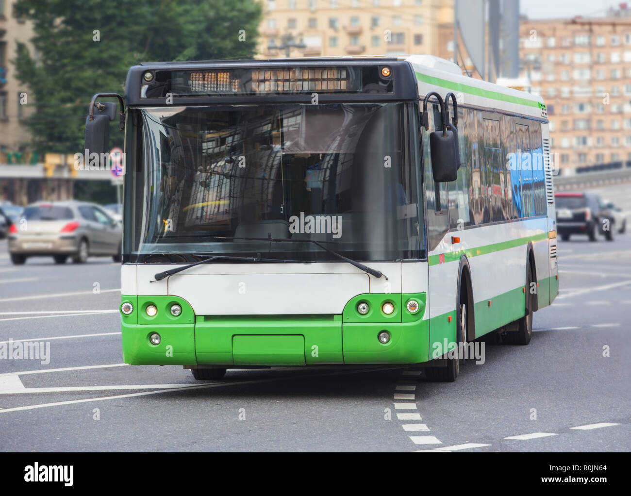 white city bus goes along street Stock Photo - Alamy