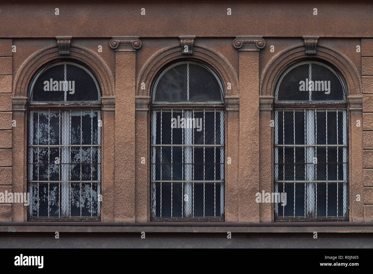 Three arched windows on an old ornate facade Stock Photo - Alamy
