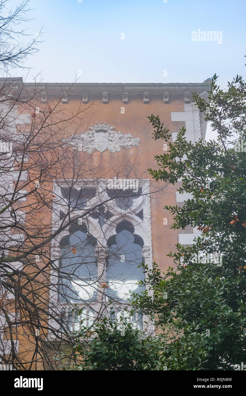 Gothic style building window behind trees at venice city, Italy Stock ...