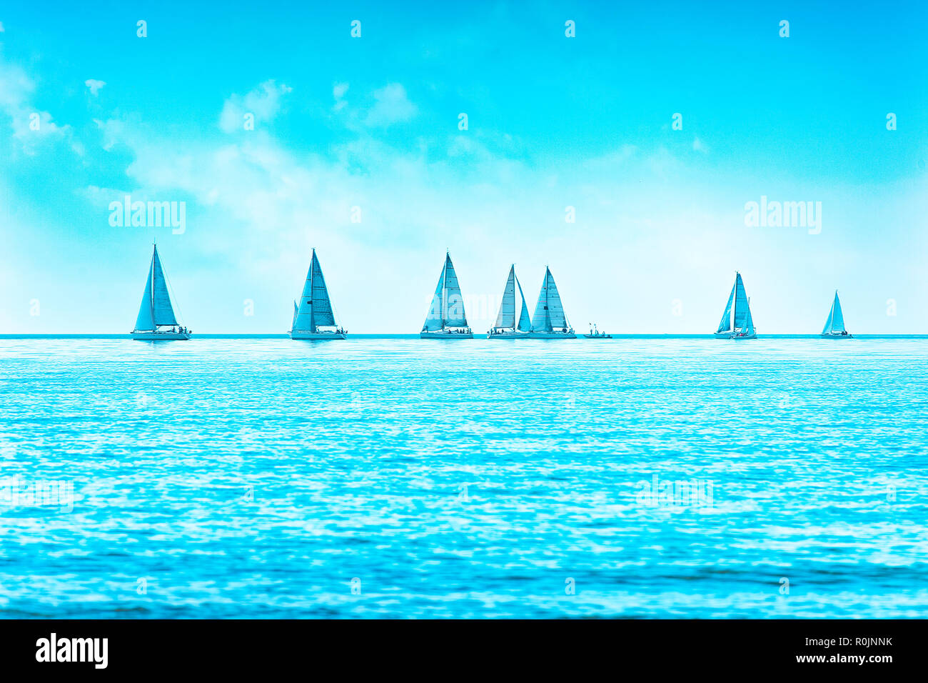 Sailing boat yacht or sailboat group regatta race on sea or ocean water ...