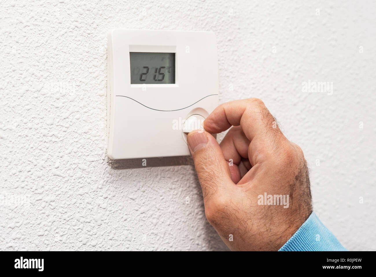 Man hand adjusting thermostat at home. Celsius temperature scale Stock ...