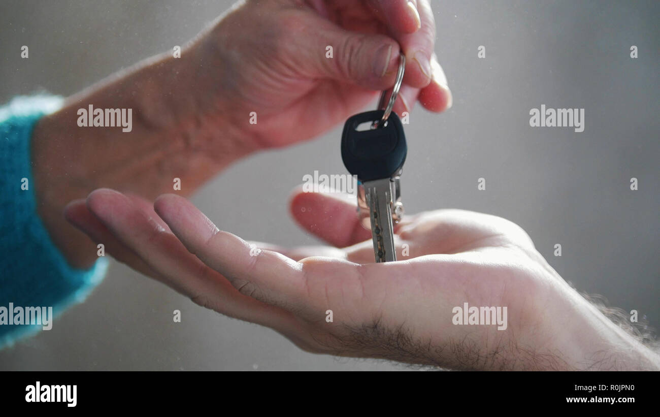 Keys on hand. Pass from hand to hand Stock Photo - Alamy