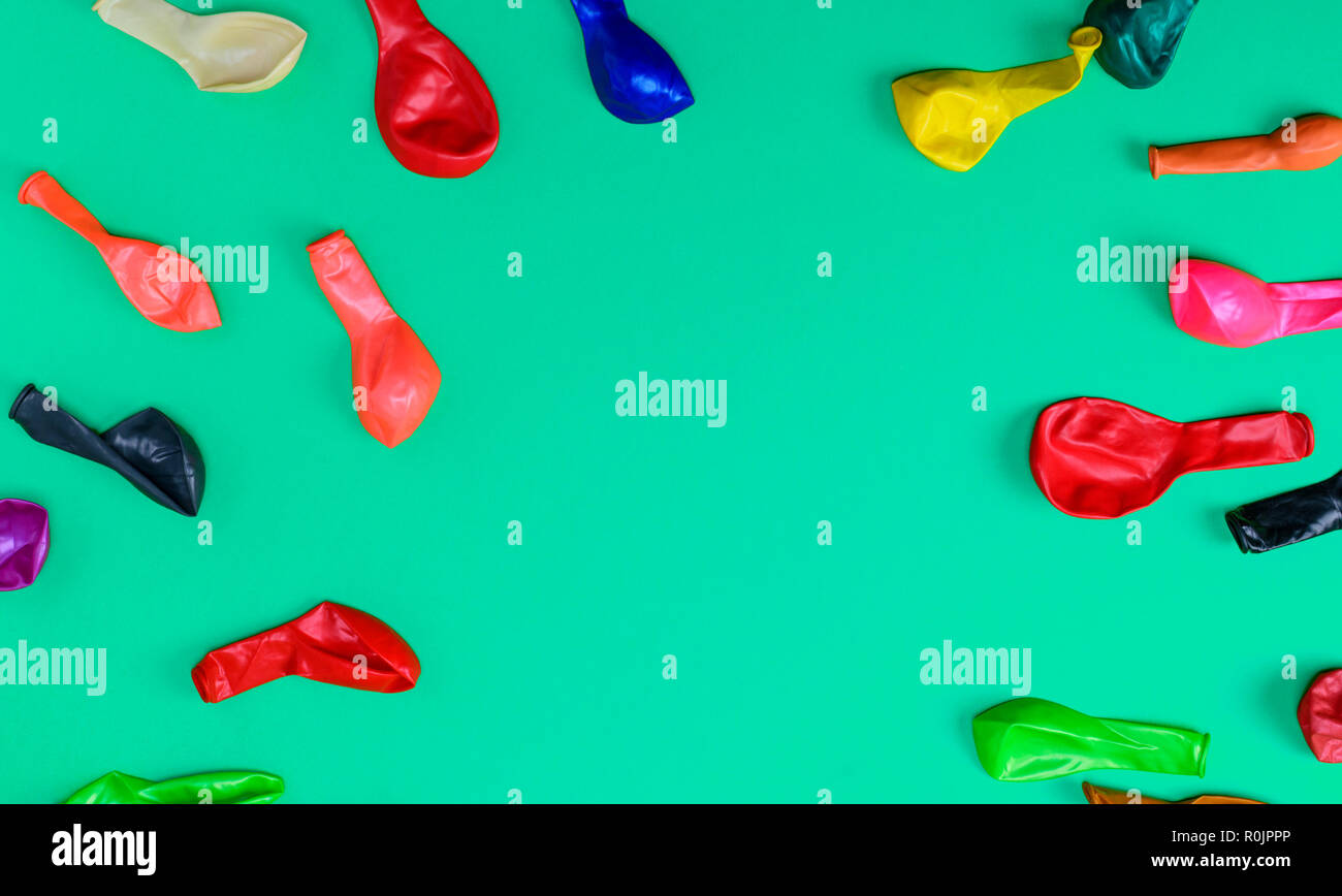 colorful deflated balloons on a green background, copy space Stock ...