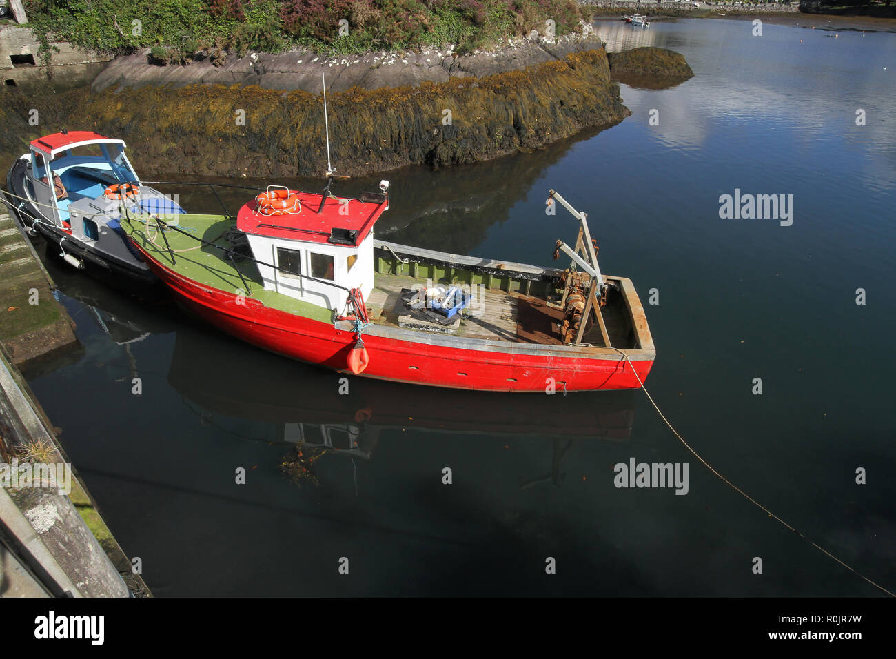 Small red inshore fishing boat in Irish harbour at Glengarriff County ...