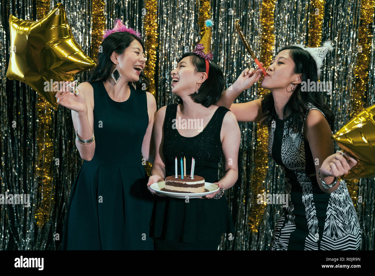 Happy friends celebrating birthday with cake in night club. young ...