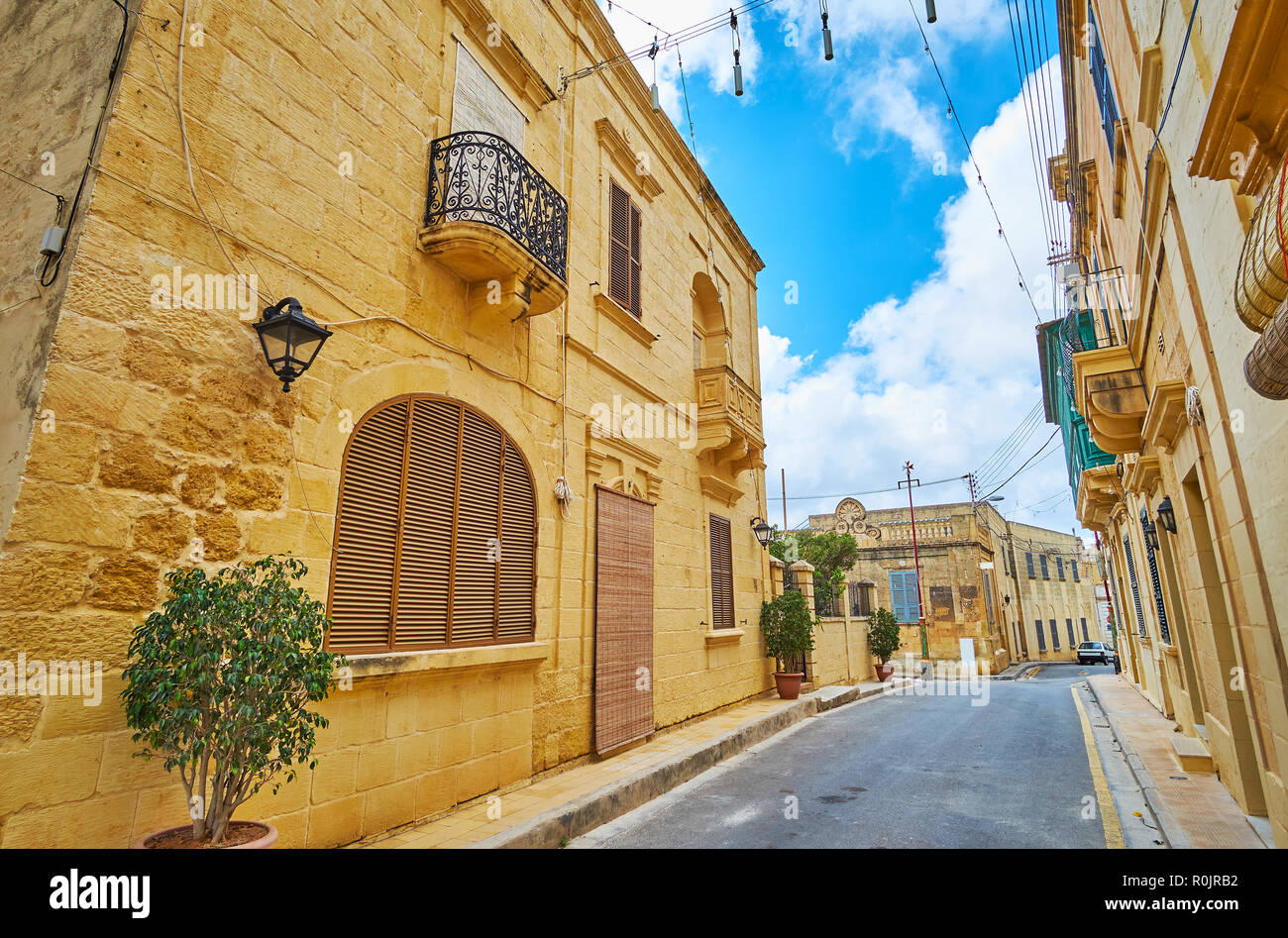 Walk the old street with scenic mansions, made of native limestone ...