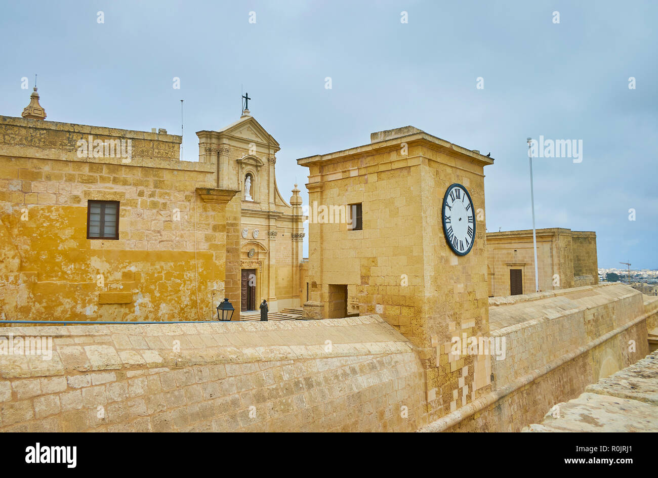 The stone clock tower and the facade of Assumption Cathedral, seen ...