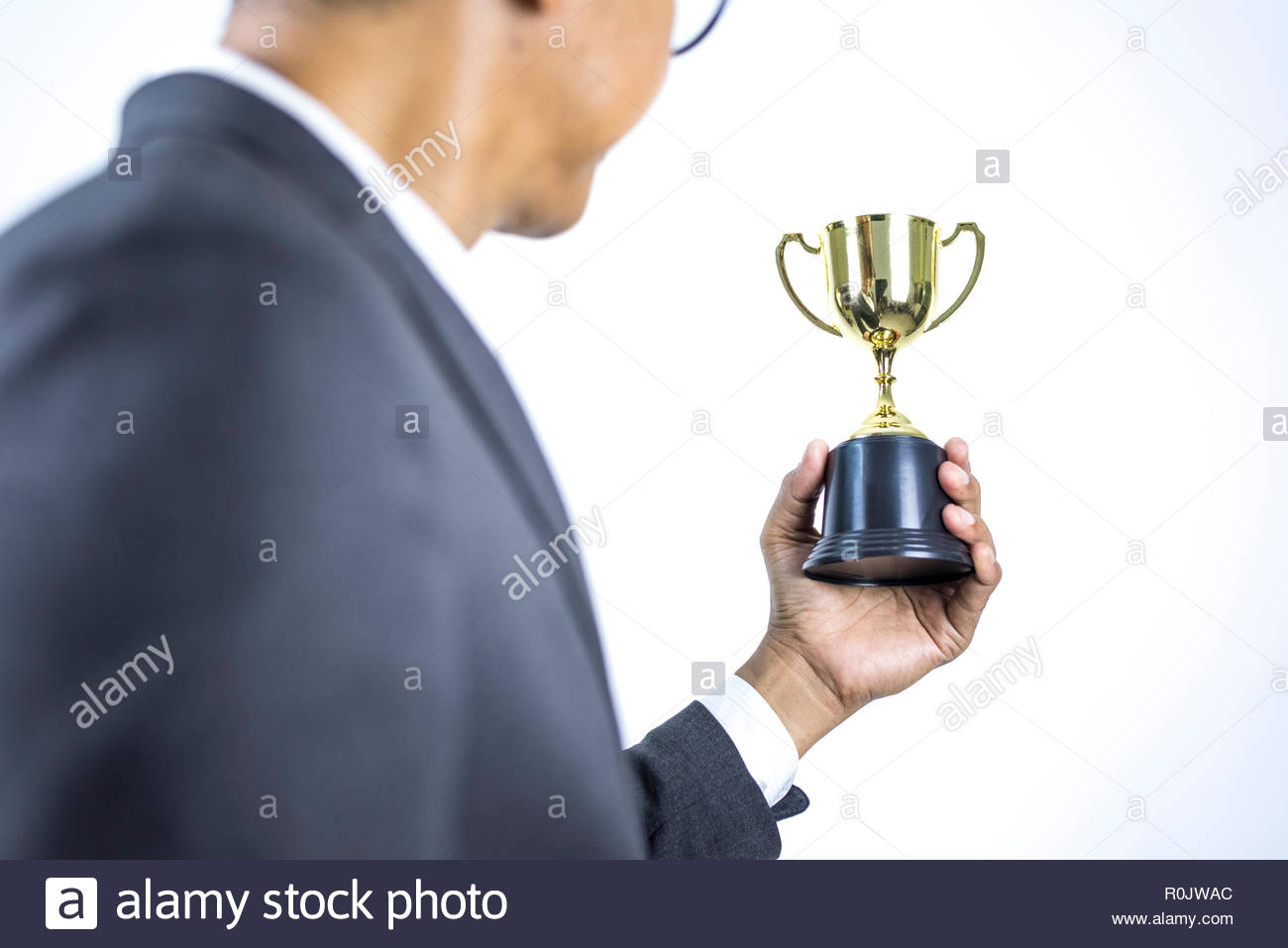 Business Man Holding Trophy Award Stock Photos & Business Man Holding ...