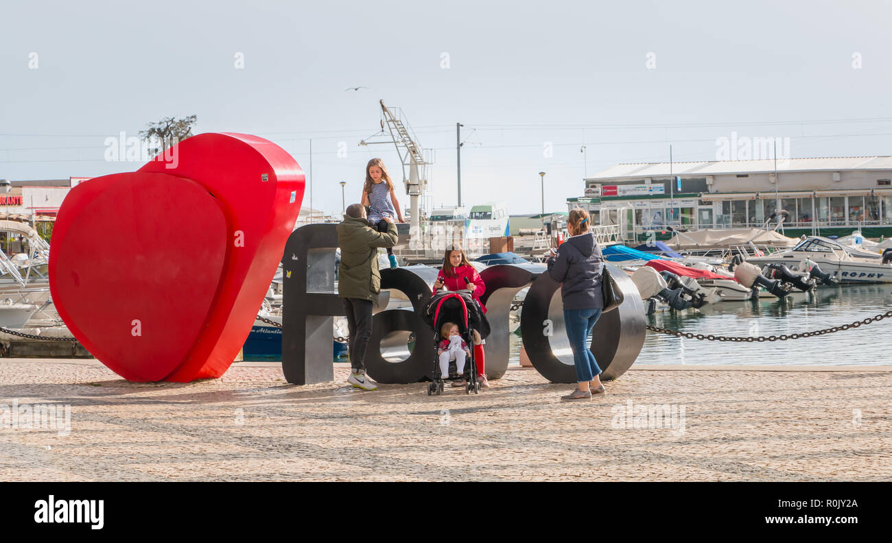 Faro, Portugal - May 1, 2018: Family mother taking a picture of her ...