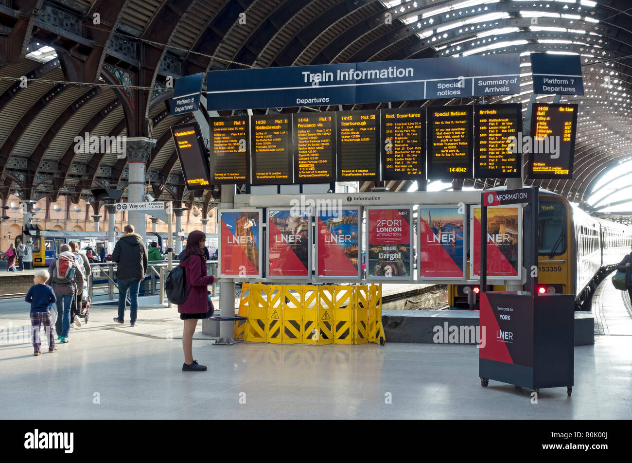 People on the concourse and arrival and departure train information ...