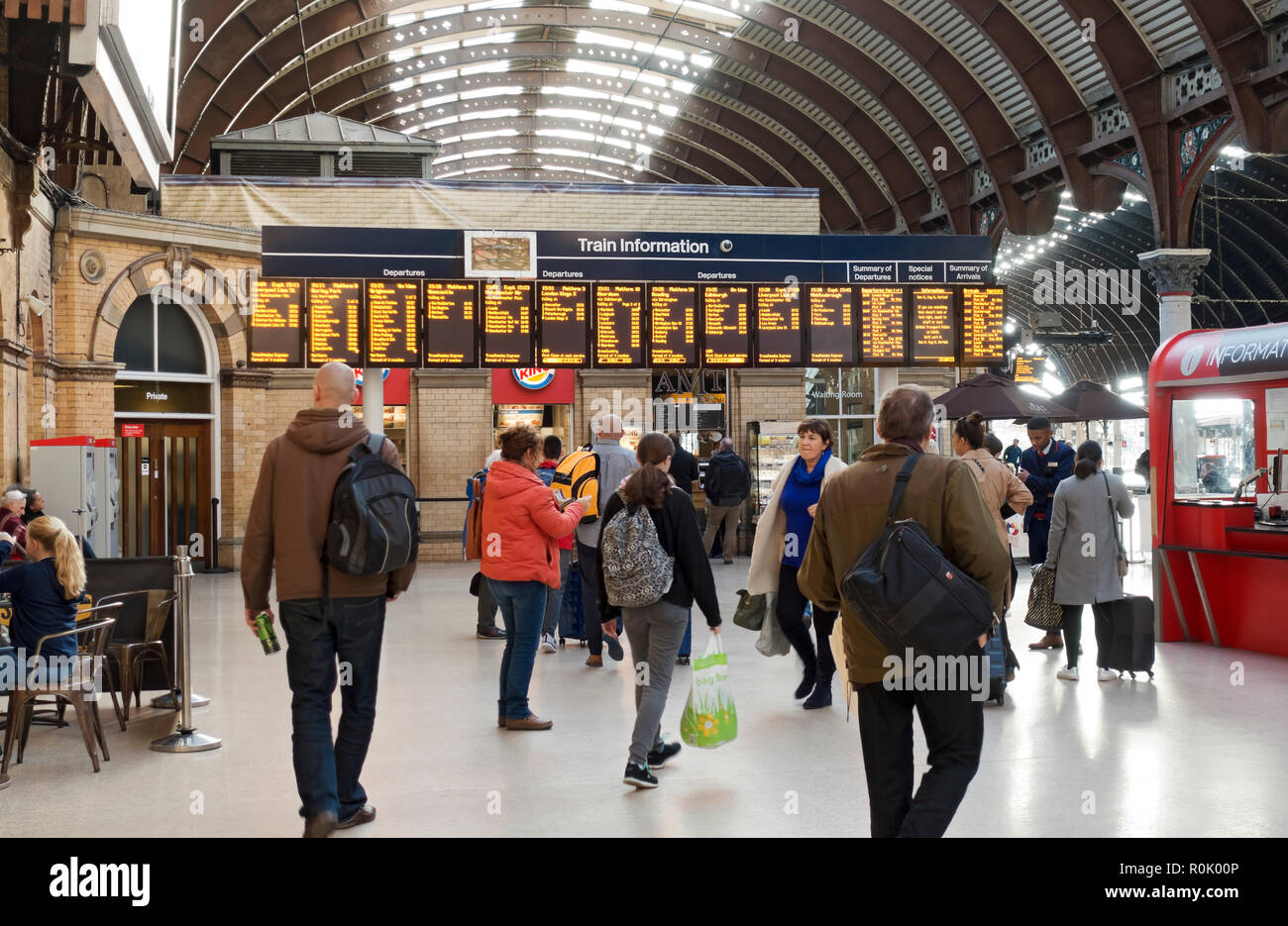 People passengers commuters at arrival and departure train information ...