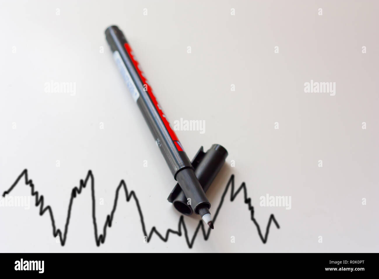 Stock chart drawing on a white paper Stock Photo - Alamy