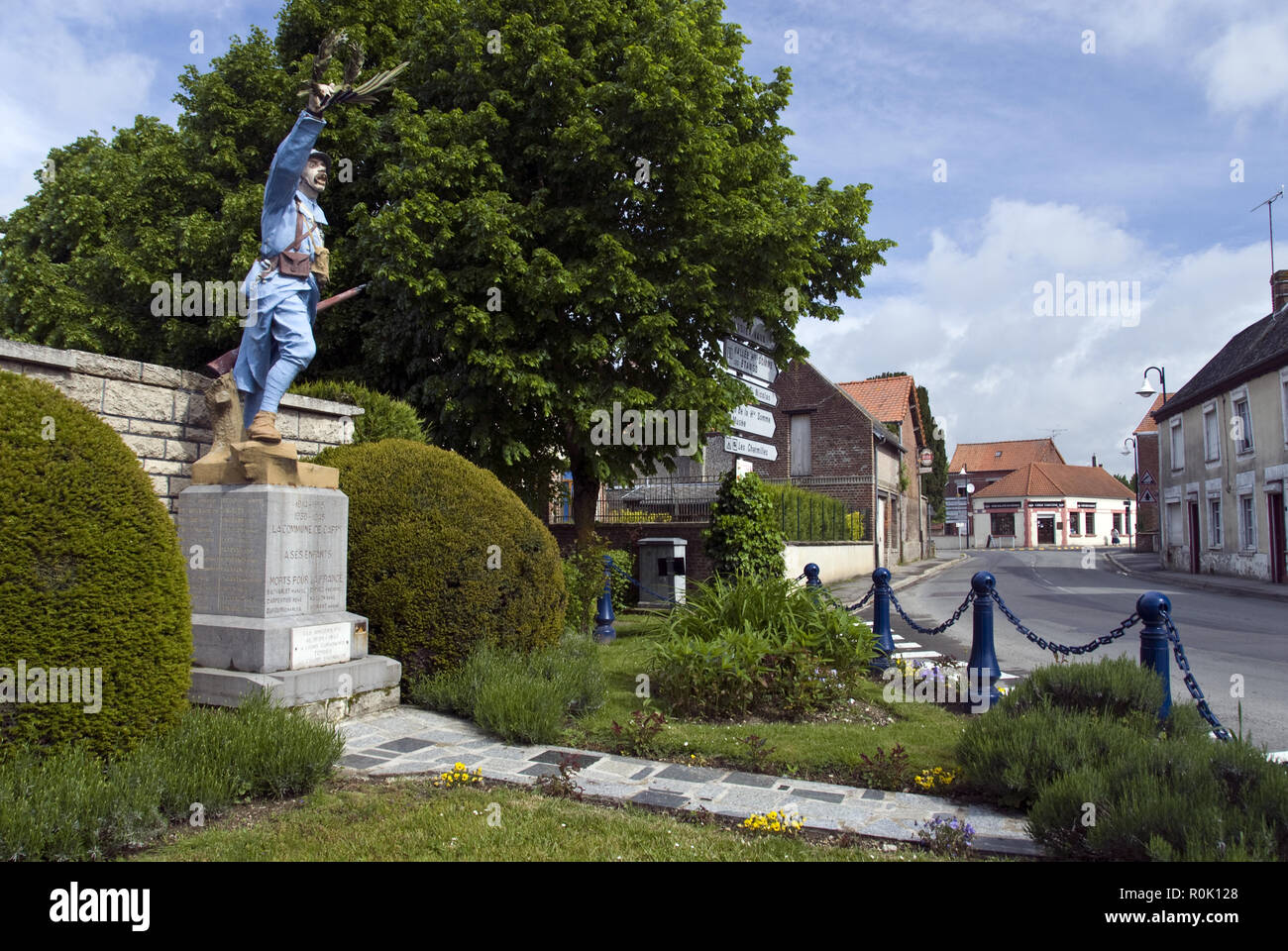 A colorfully painted statue of a WW I French soldier stands as a war ...