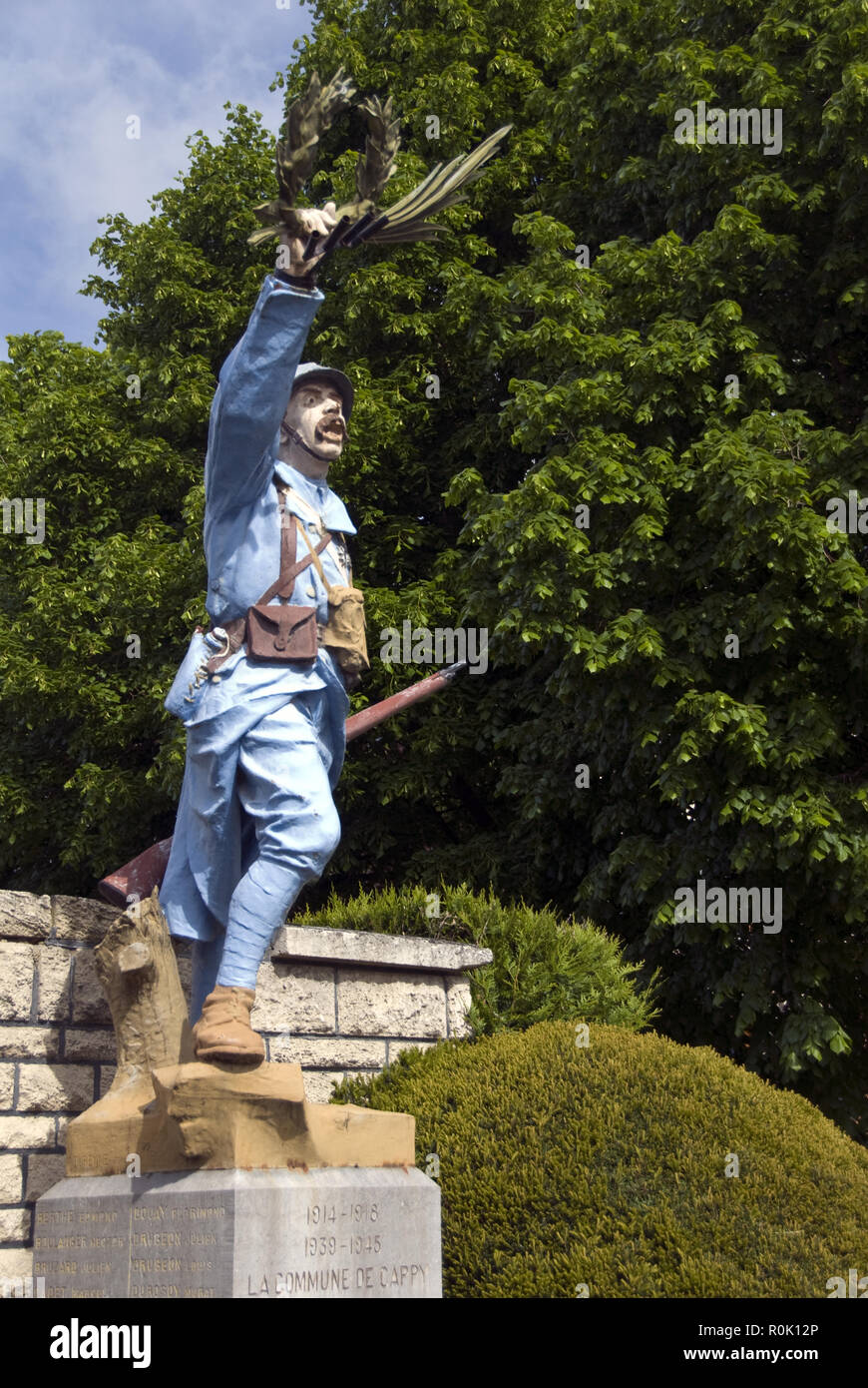 A colorfully painted statue of a WW I French soldier stands as a war ...