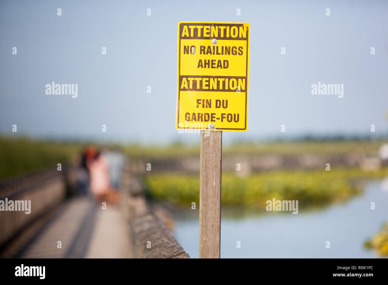 Yellow and Brown Boardwalk Sign Warning No Railing Ahead Stock Photo ...