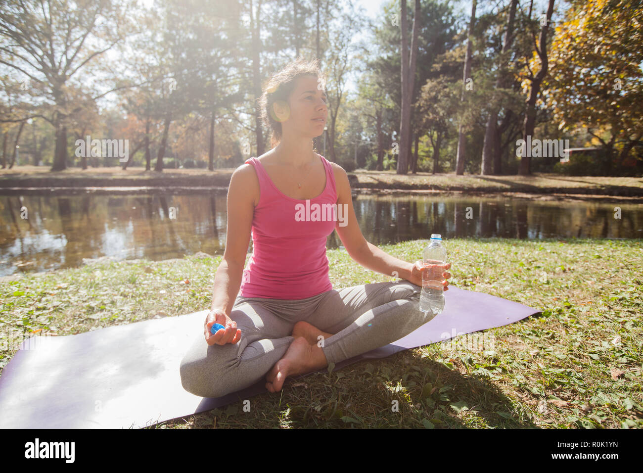 Woman Relax After Yoga Exercise In Park, Sitting On Fitness Mat And ...