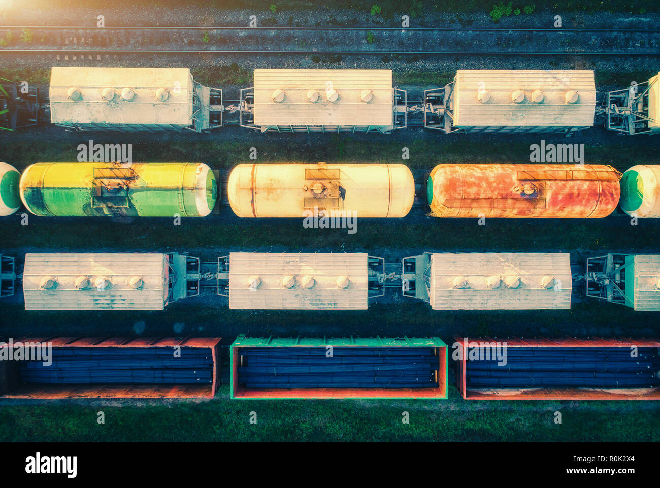 Aerial view of freight trains at sunset. Railway cargo wagons with ...