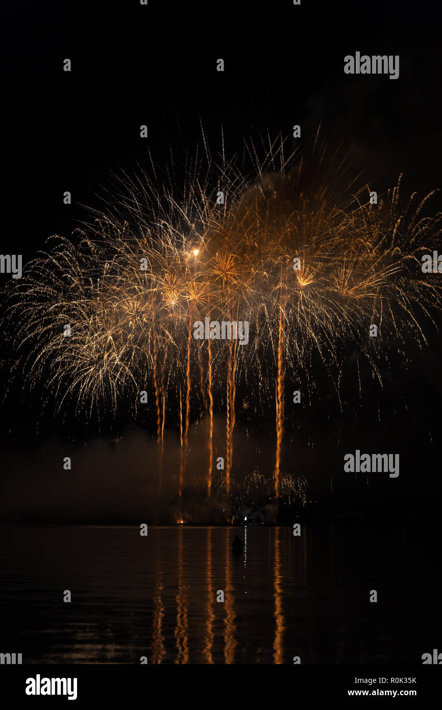 Huge golden rain in fireworks over Brno's Dam with lake reflection ...