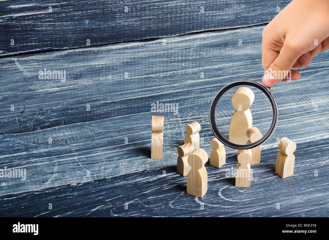 Magnifying glass is looking at the children gathered around the teacher ...