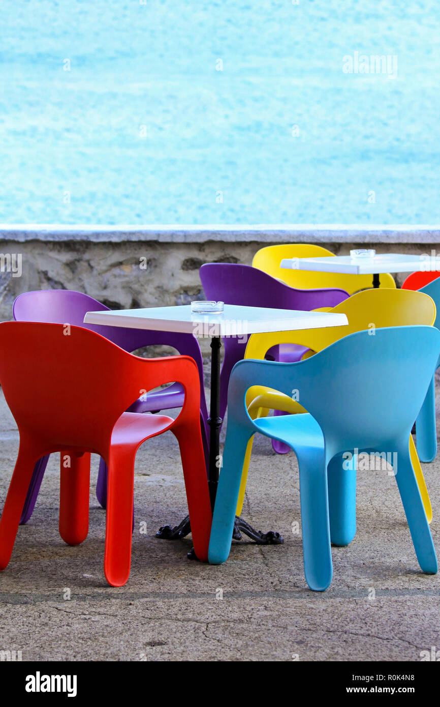 Colourful plastic chairs at sea side balcony Stock Photo - Alamy