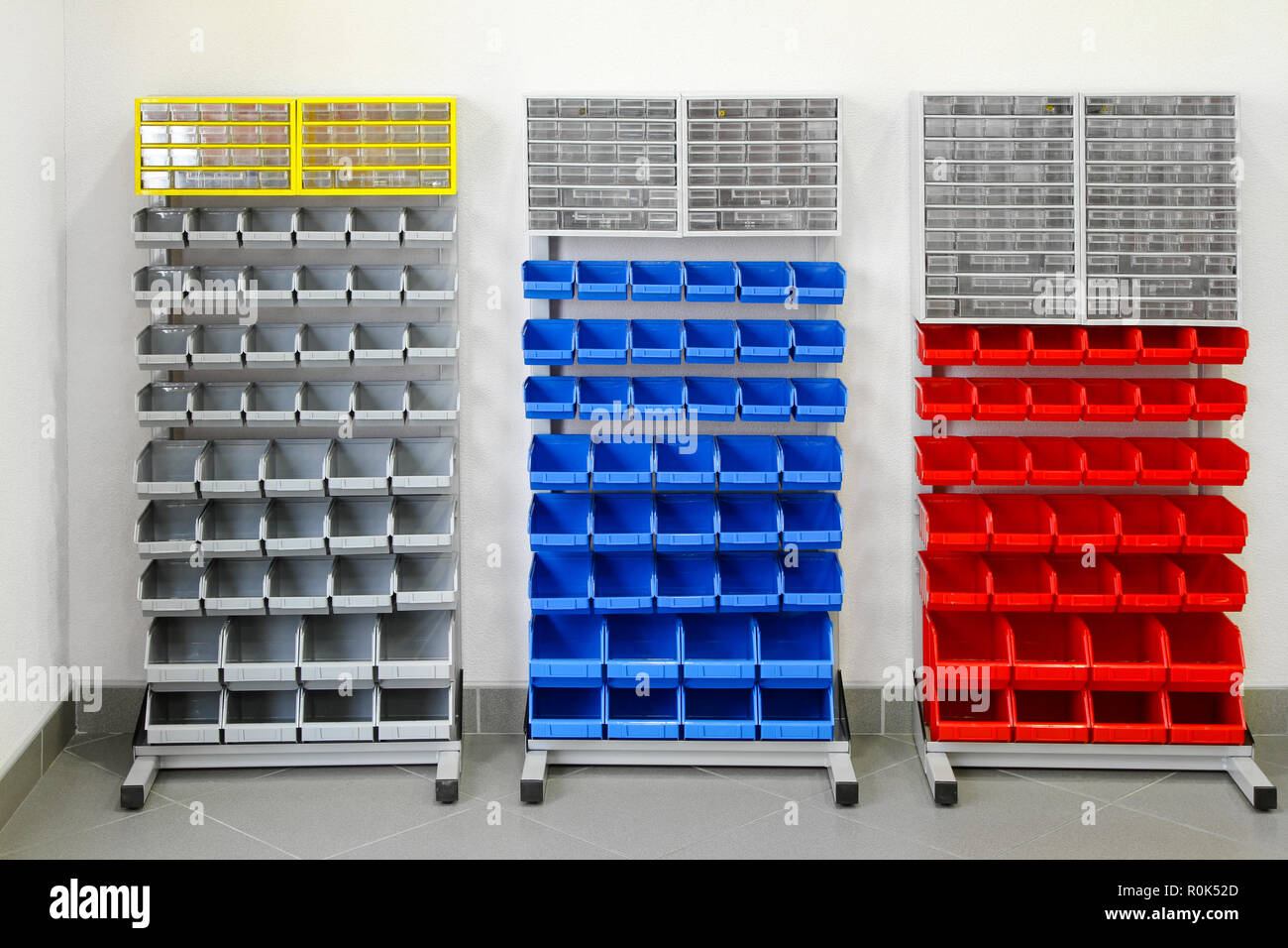 Colorful plastic shelves for inventory in workshop Stock Photo - Alamy