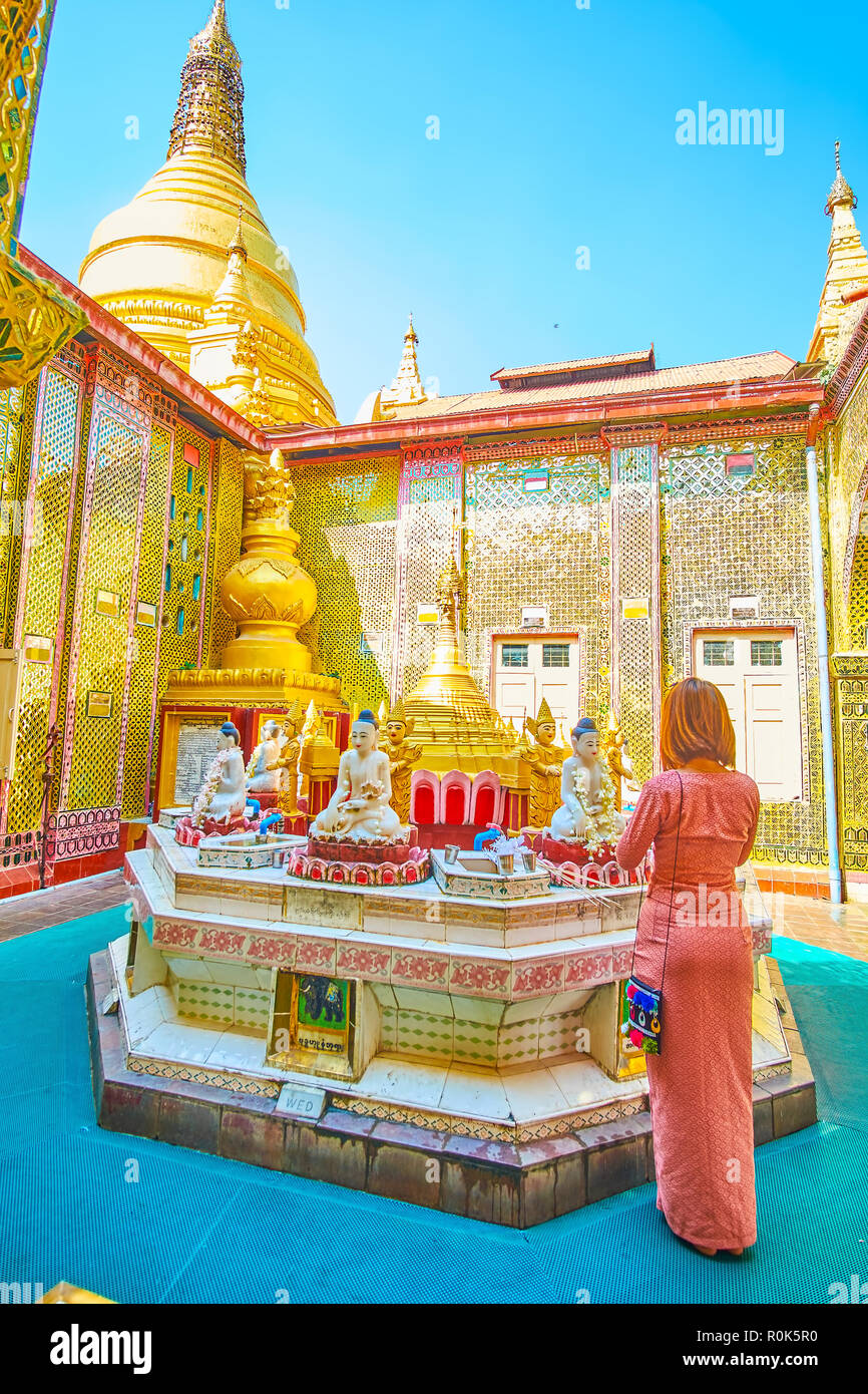 The Burmere worshiper pray at the altar in Su Taung Pyae Pagoda ...
