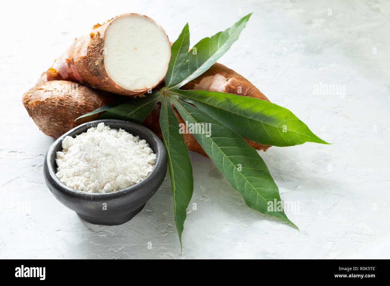 Raw yucca starch on the wooden table - Manihot esculenta Stock Photo ...