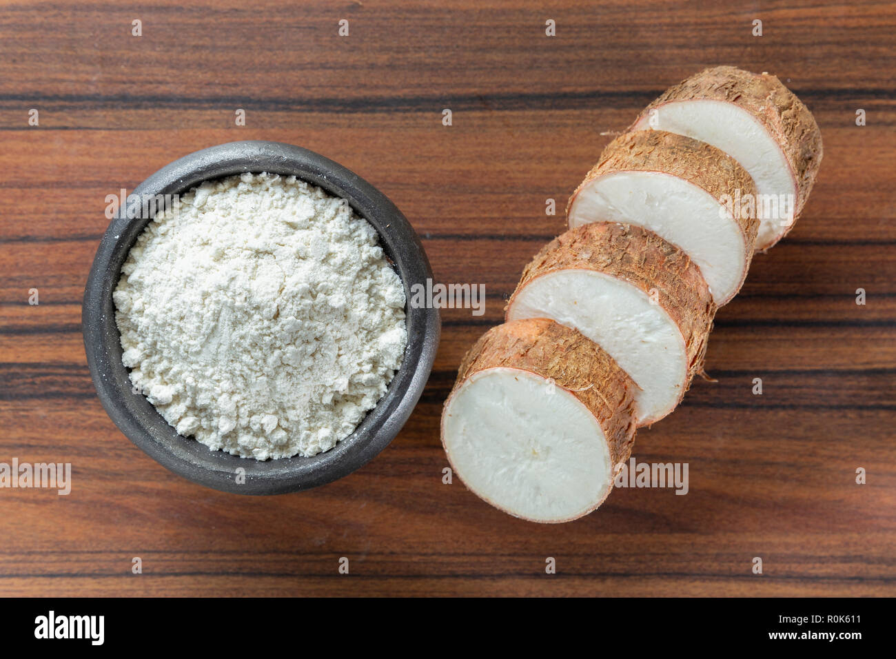 Raw yucca starch on the wooden table - Manihot esculenta Stock Photo ...