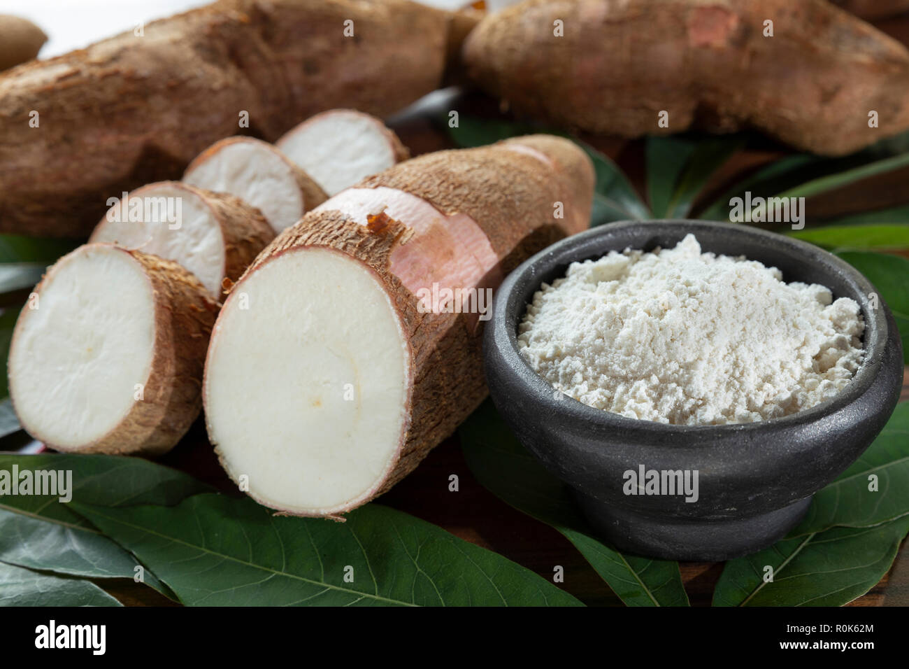 Raw yucca starch on the wooden table - Manihot esculenta Stock Photo ...