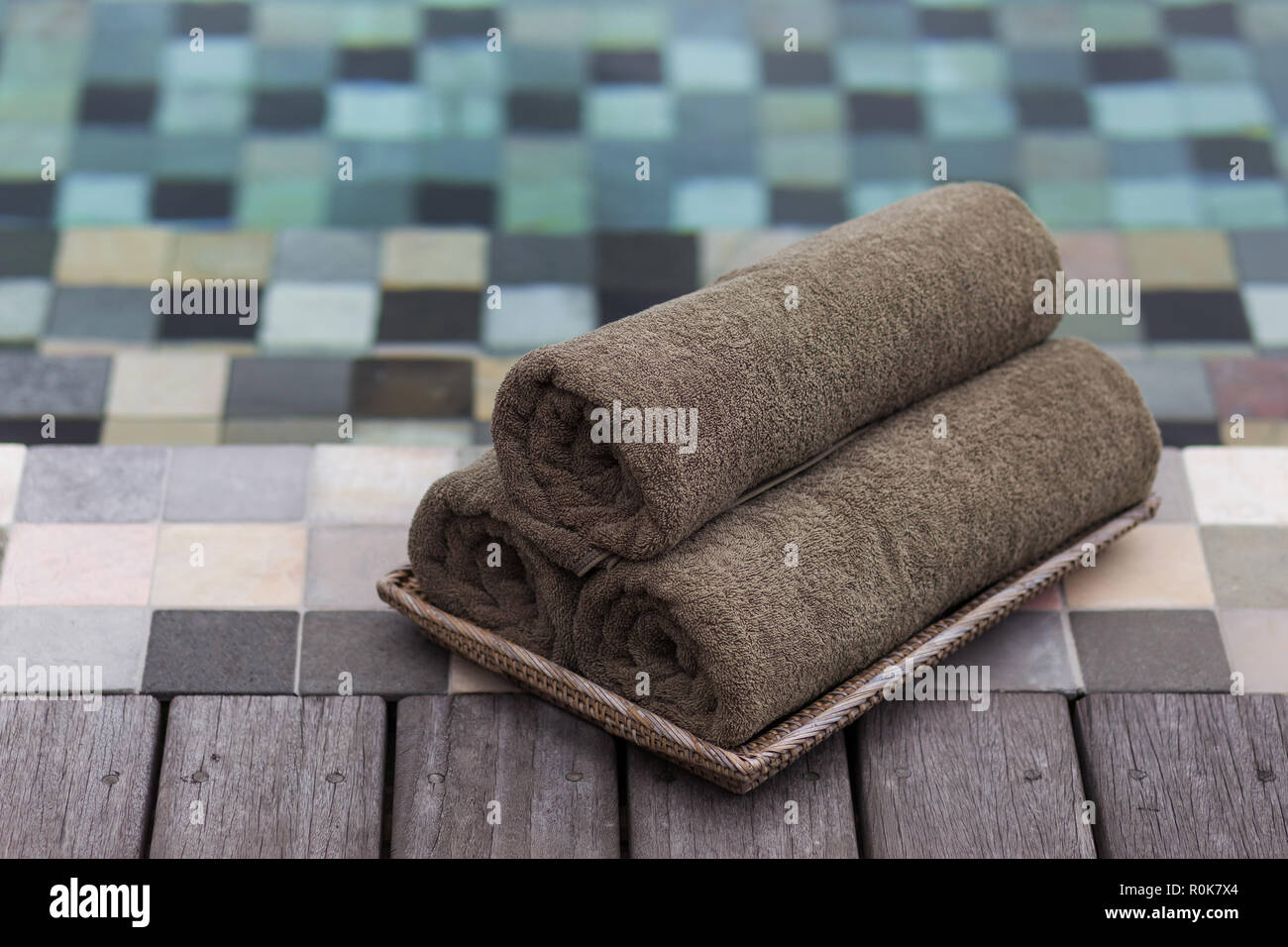 Three grey towels rolled near swimming pool Stock Photo - Alamy